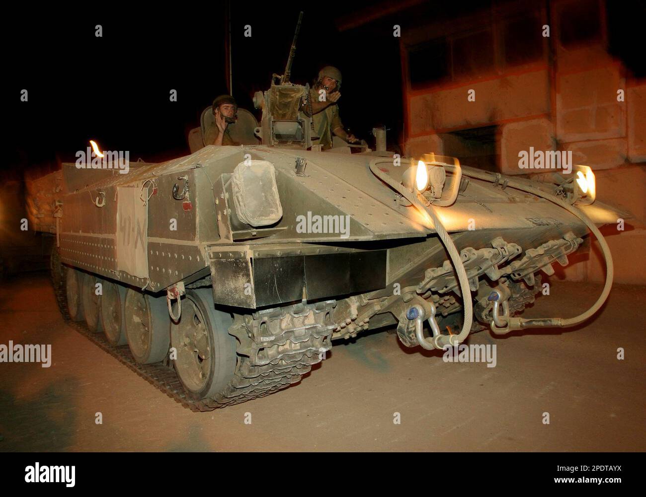 An Israeli army armored vehicle leaves the Gaza Strip through the Kerem ...