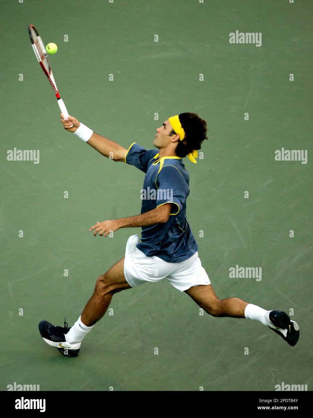 Roger Federer of Switzerland returns to Andre Agassi of the United ...