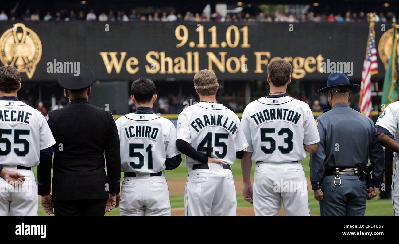 Seattle Mariners players line up with firefighters and police officers ...
