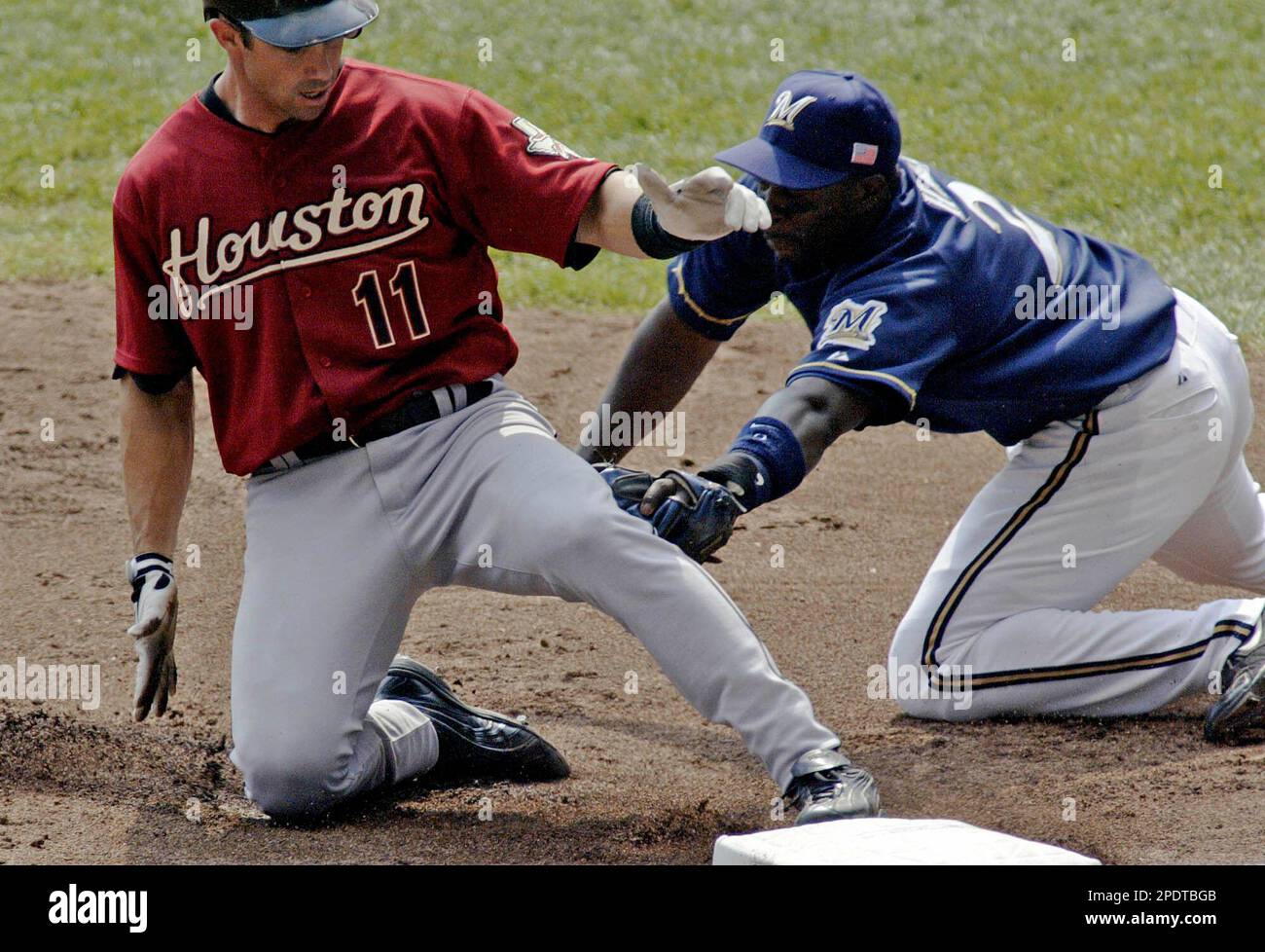 Houston Astros' Brad Ausmus, left , is safe at third base as Milwaukee ...