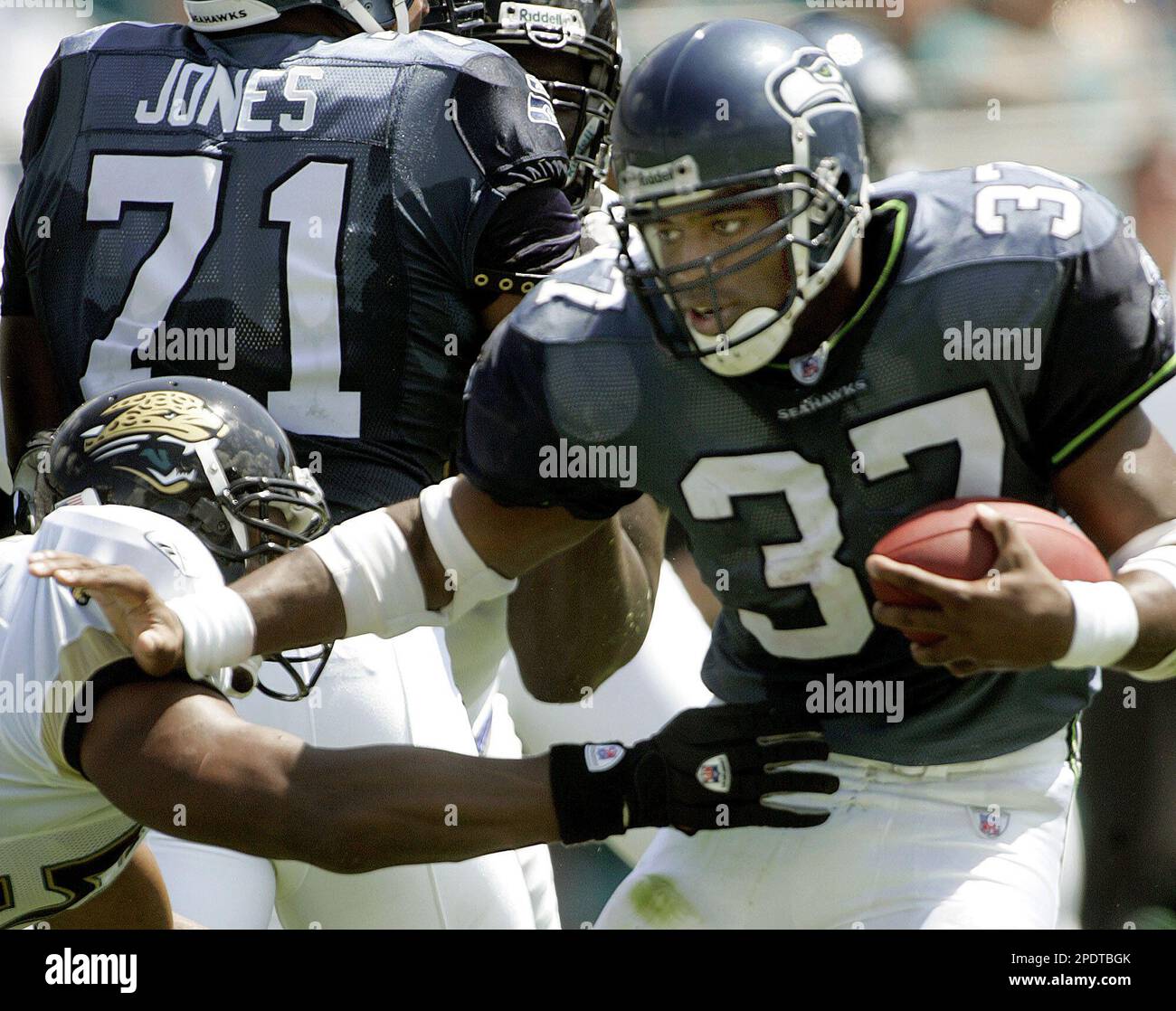 Seattle Seahawks running back Shaun Alexander, right, pushes away a ...