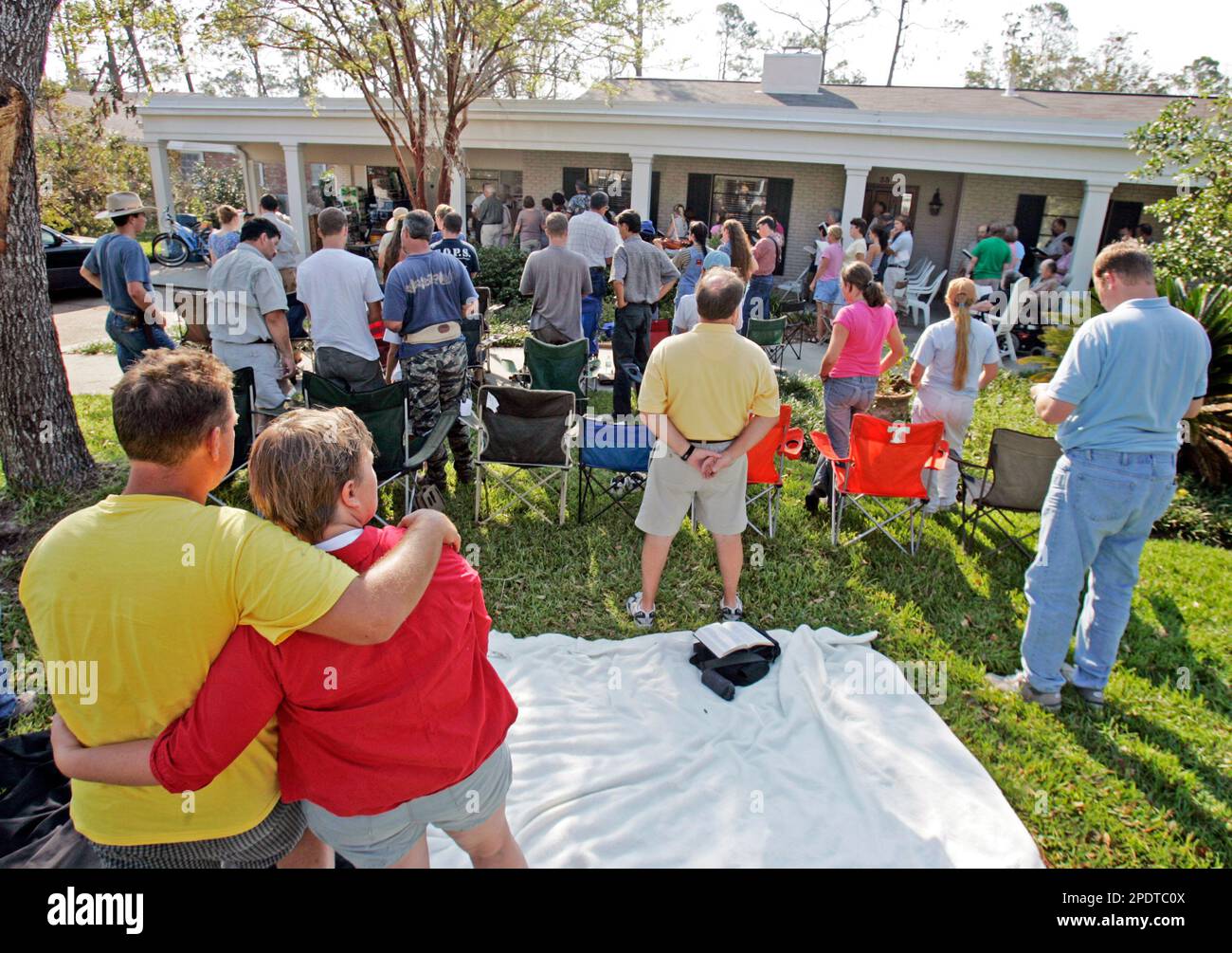 Nick Fuqua and his wife Natalie, left, attend a religious service by ...
