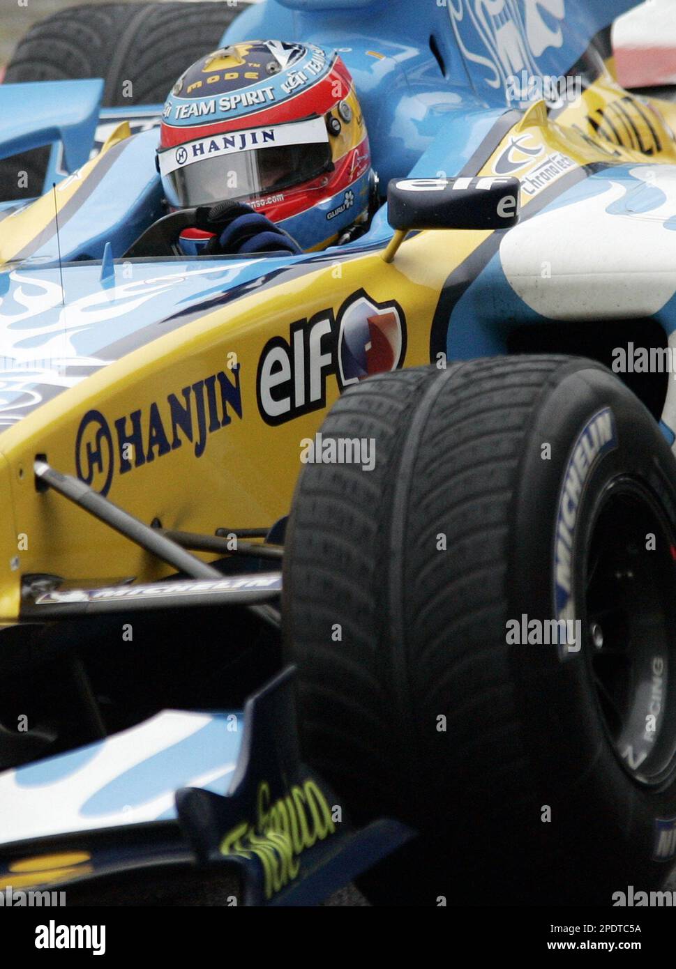 Spain's Fernando Alonso of the Renault team steers his car though a ...