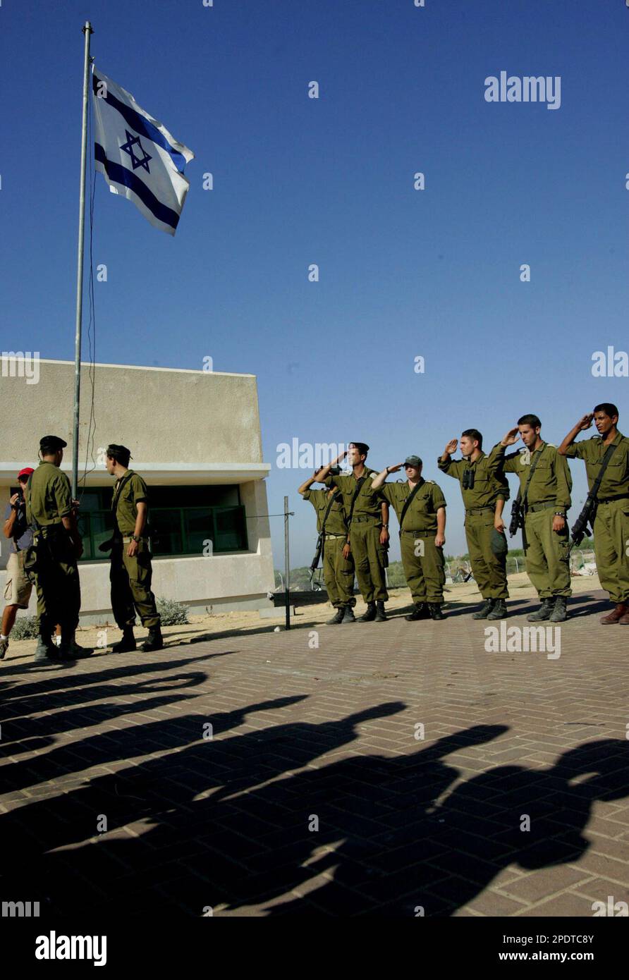 Israeli soldiers salute during a ceremony to remove the Israeli flag at ...