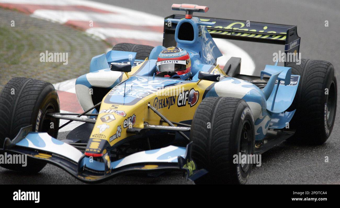 Spain's Fernando Alonso of the Renault team steers his car though a ...