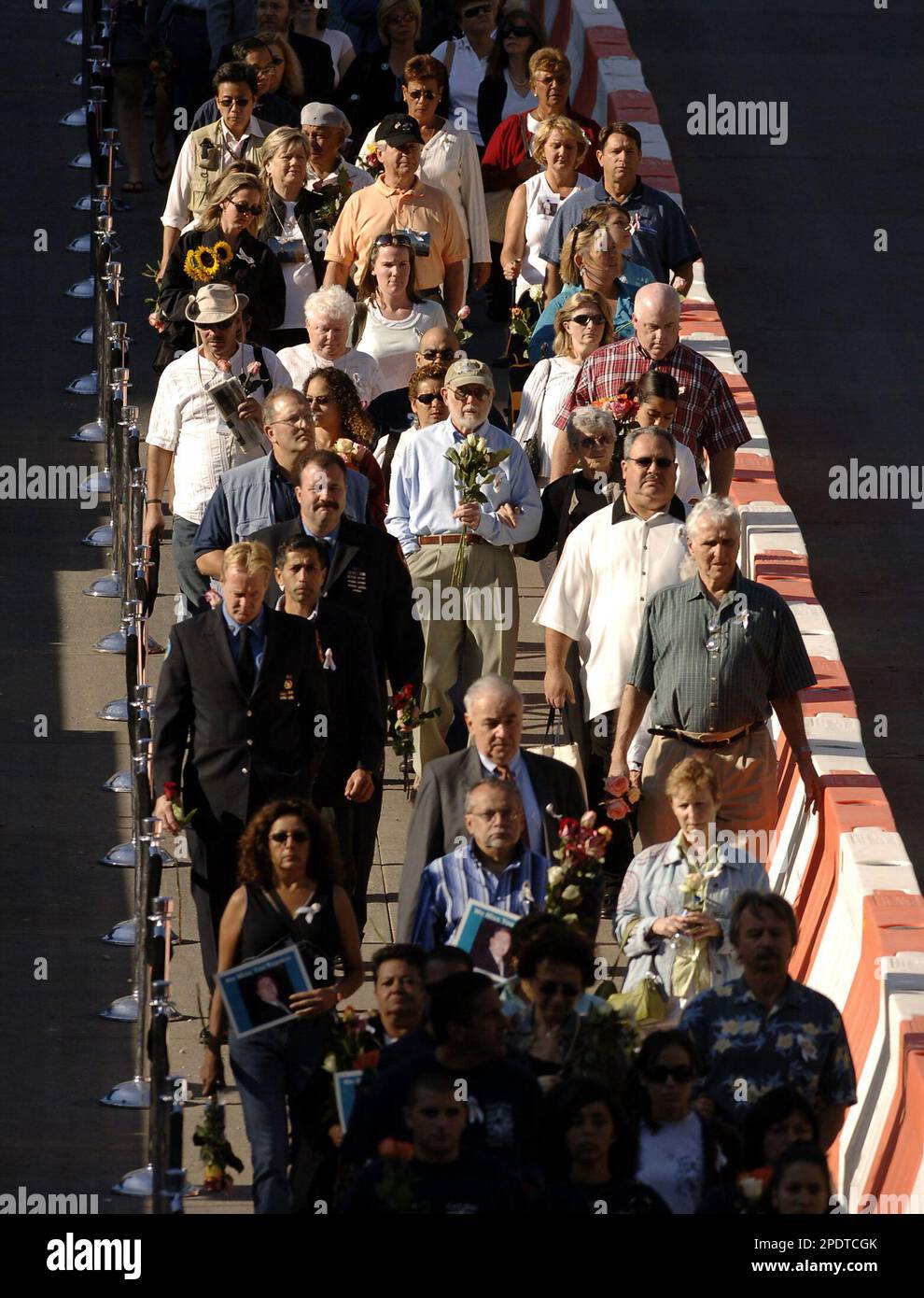 People walk down a ramp to the footprints of the World Trade Center ...