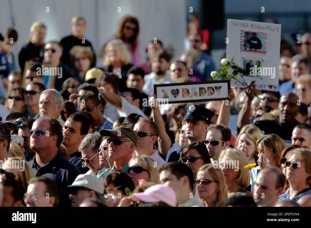 Friends and relatives of the victims of the Sept. 11 attacks, hold up ...