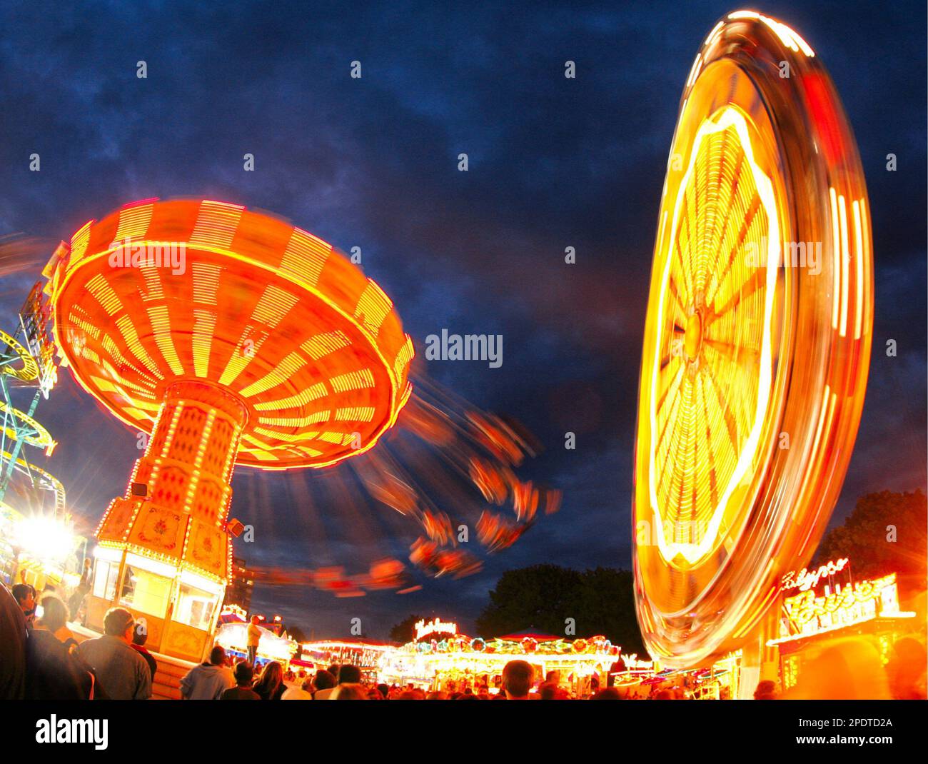 Long time exposure of visitors and fairground rides at the so called ...