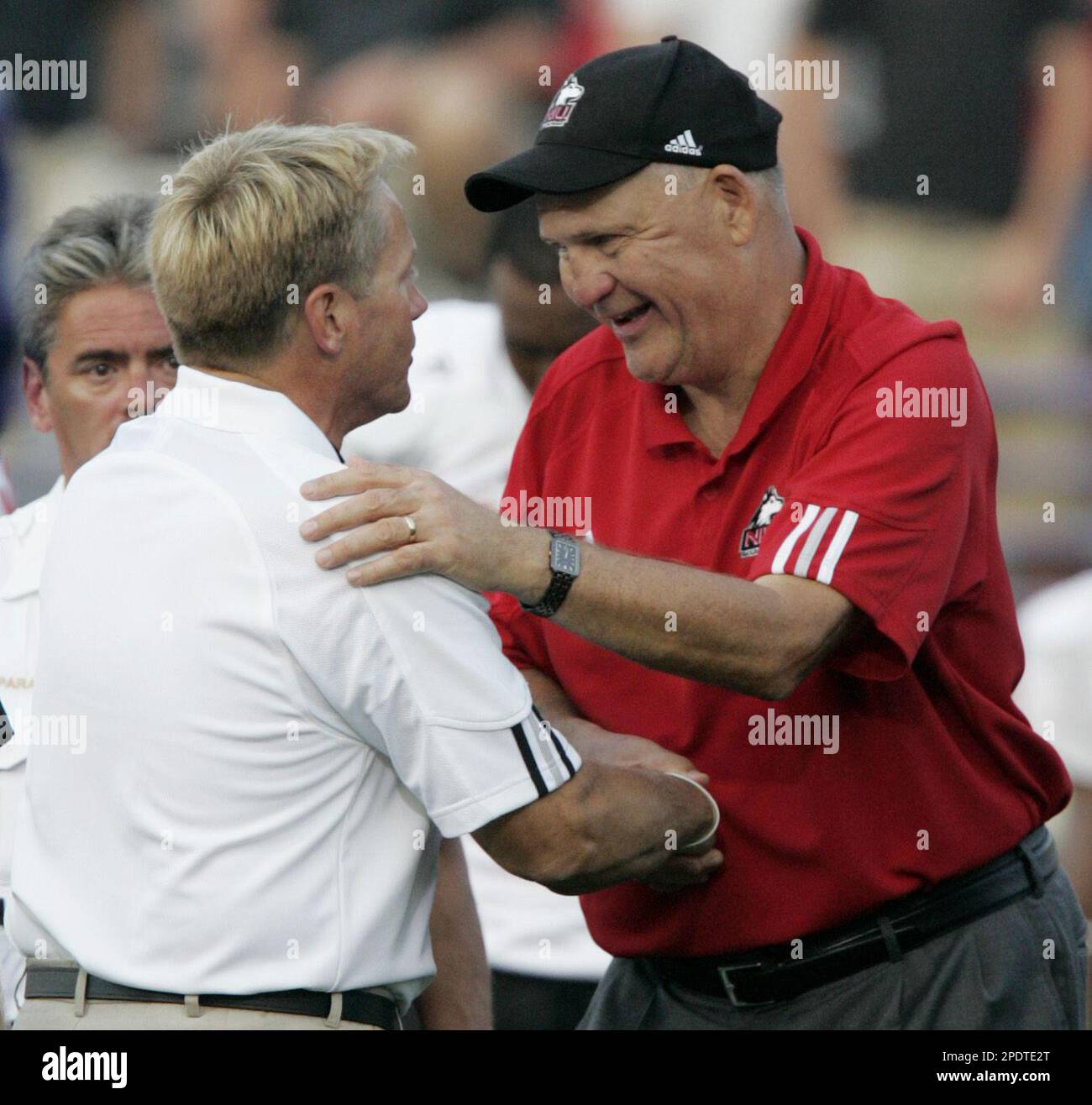 Northwestern coach Randy Walker, left, meets with Northern Illinois ...