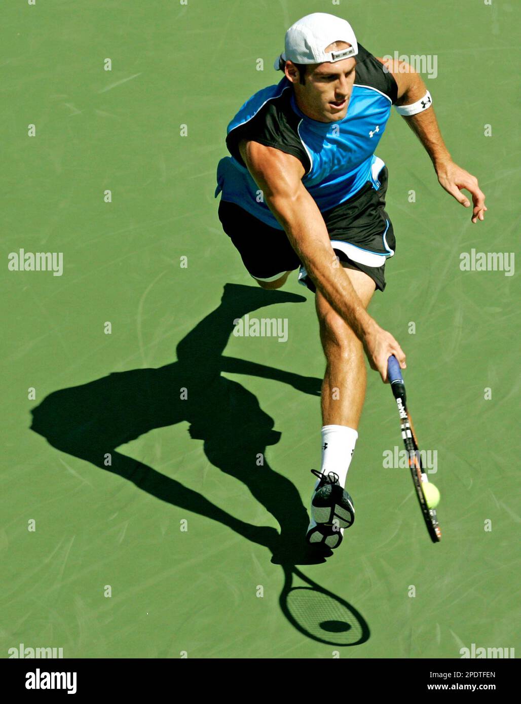 Robby Ginepri of the United States returns to Andre Agassi of the ...