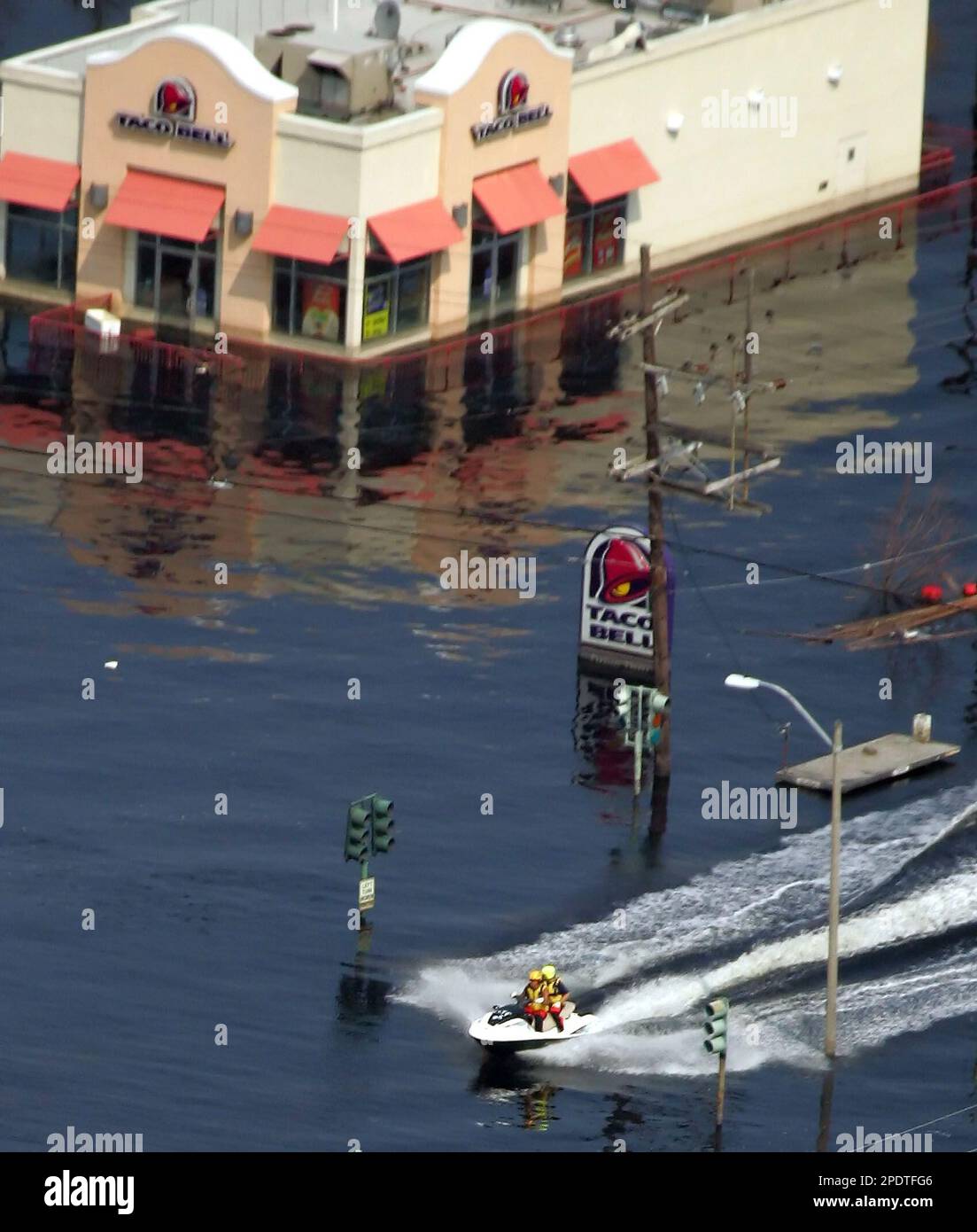 A watercraft passes near a Taco Bell in the aftermath of Hurricane ...
