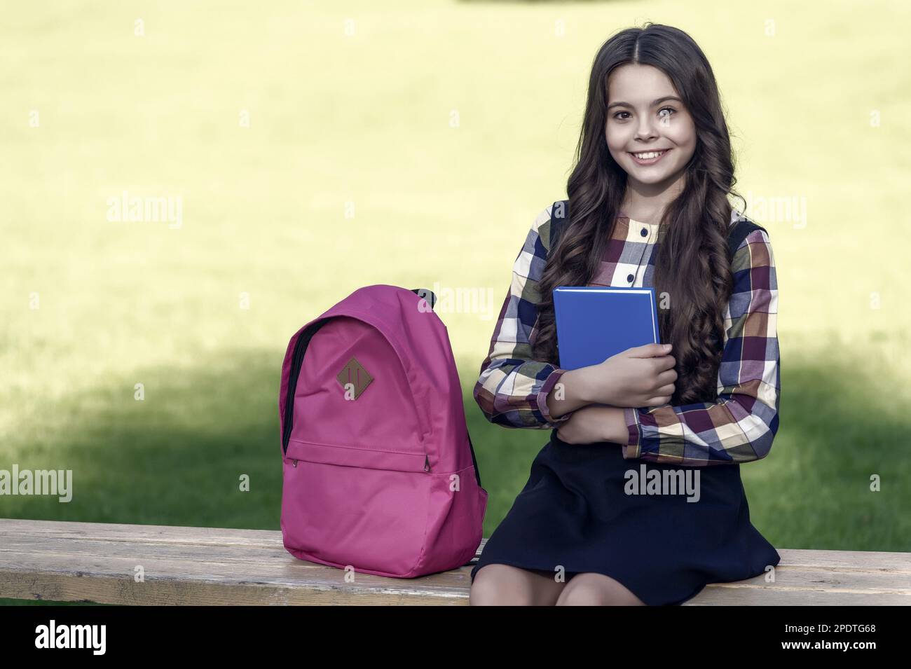For mind that is eager to learn. Happy kid hold book sitting on bench ...