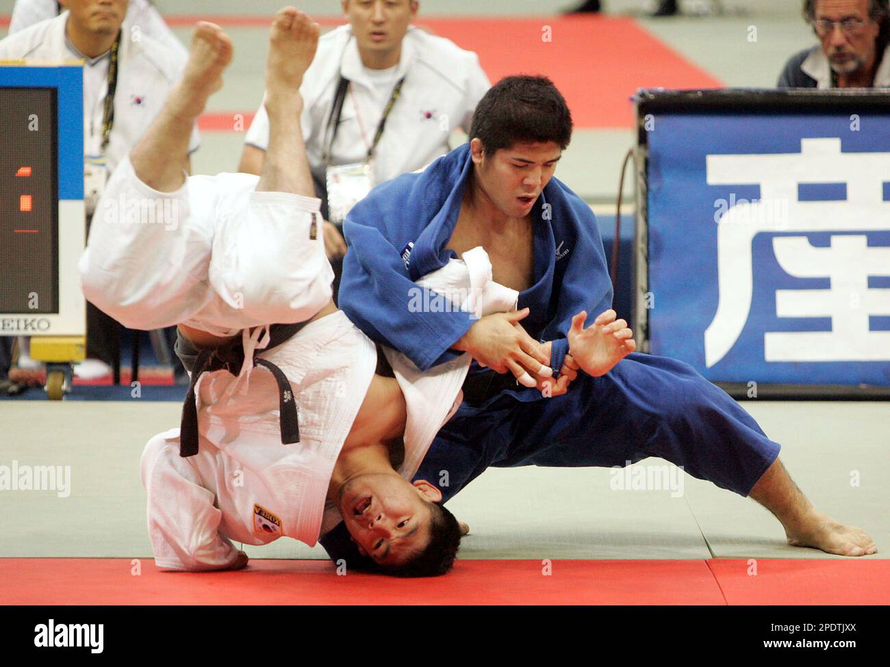 Japan's Hiroshi Izumi, in blue, throws Korea's Hee Tae Hwang in the Men's -90kg Judo at the 24th ...