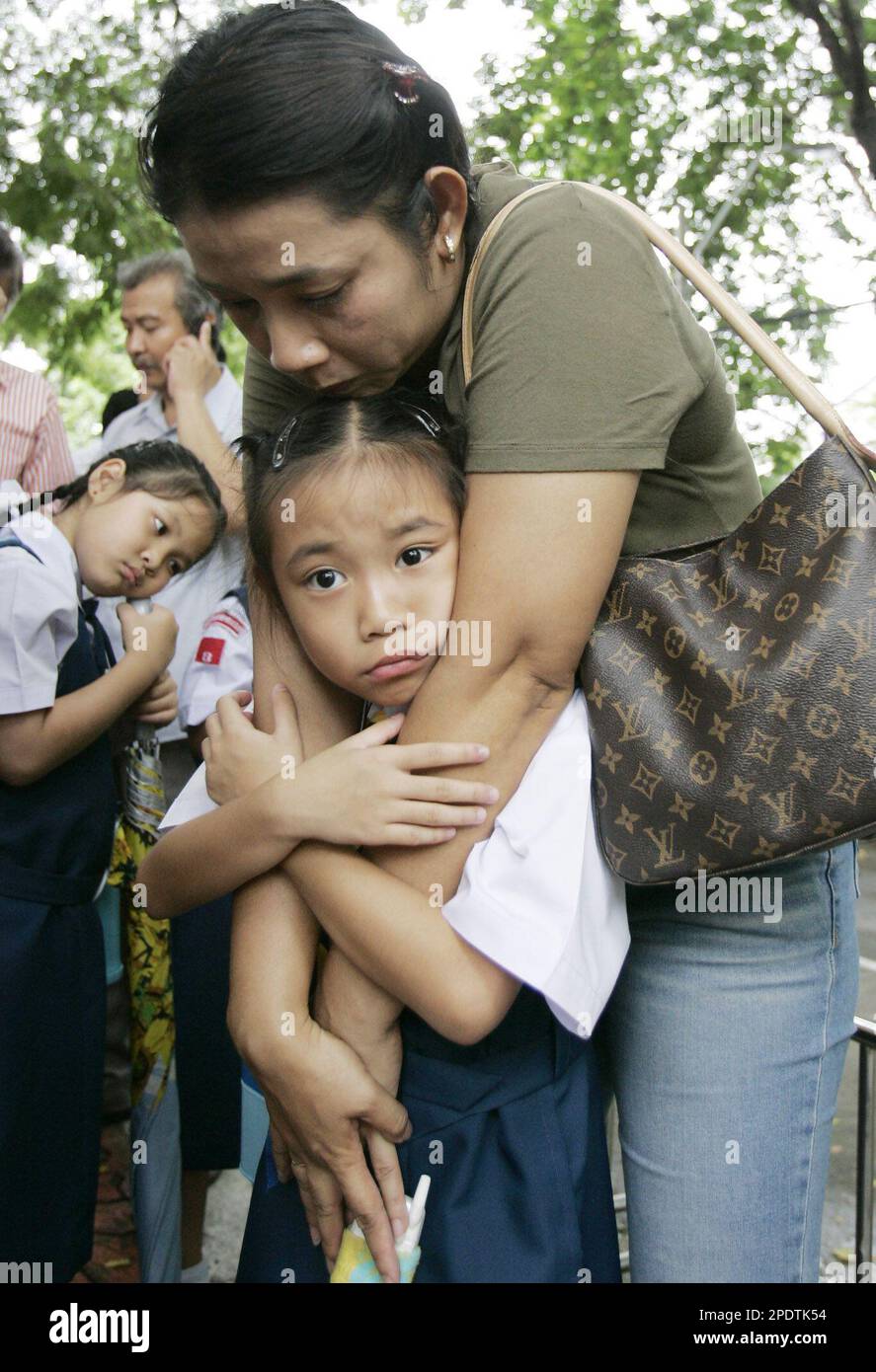 Thai woman hugs her daughter at a prestigious girl's school St. Joseph ...