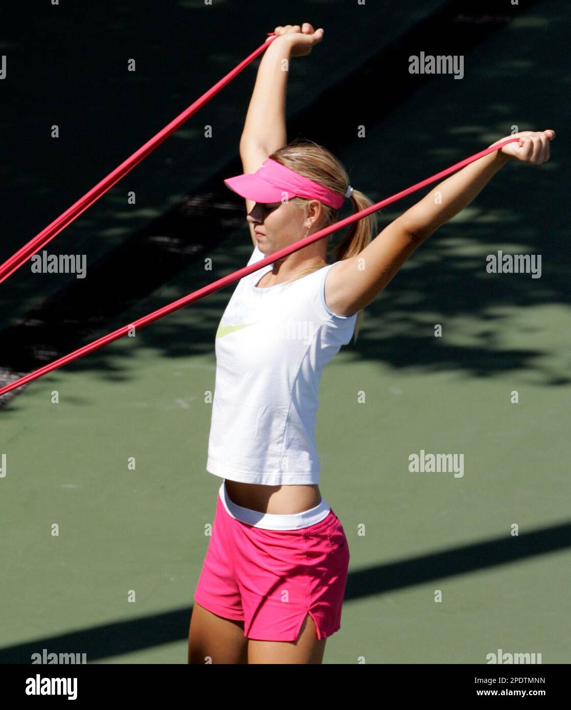 Maria Sharapova, of Russia, does stretching exercises on a practice ...