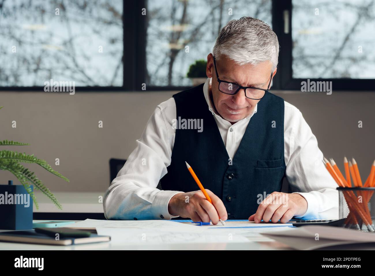 Mature businessman working at the desk in office Stock Photo - Alamy
