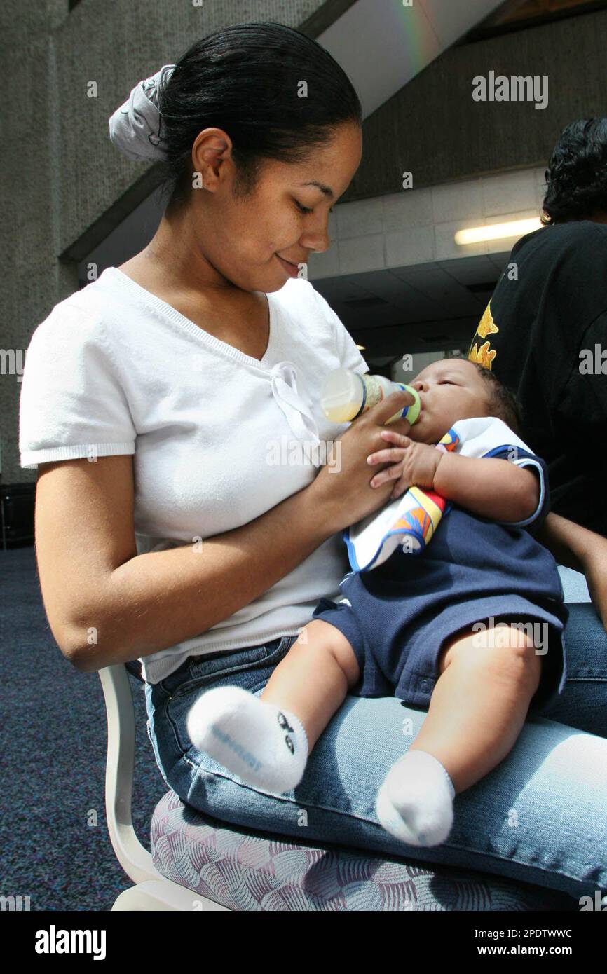 Purity Marsh feeds her 3-month-old son Ethan Marsh in a temporary ...