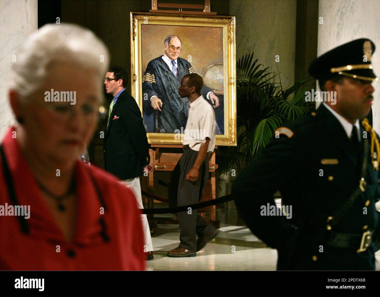 Public mourners file past the official portrait of Chief Justice ...