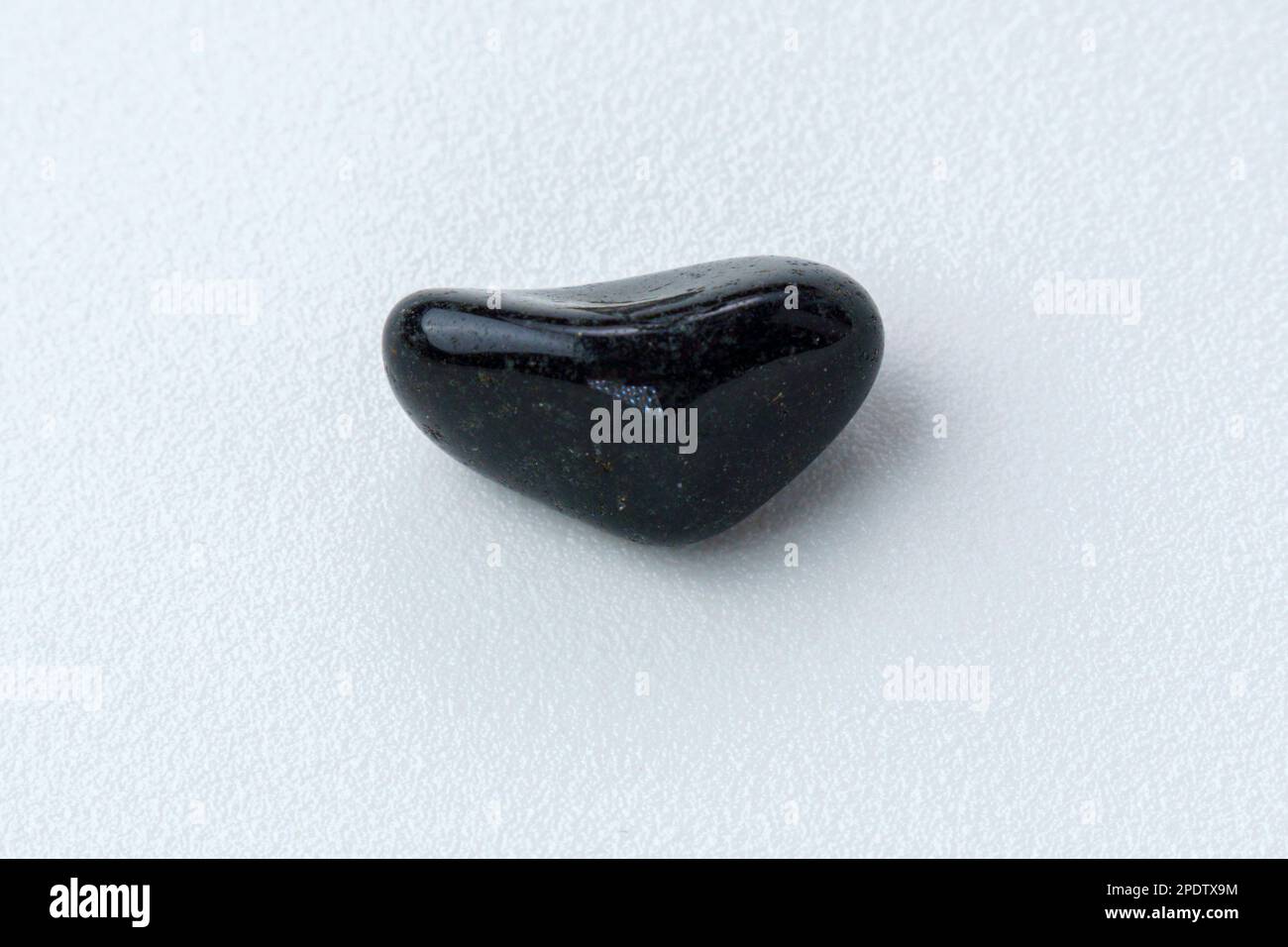 Close up of natural mineral from geological collection tumbled black ...