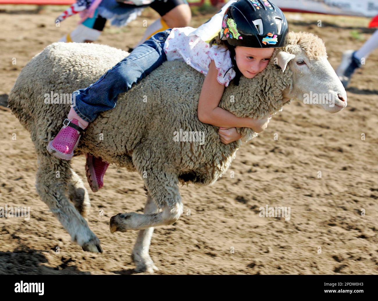 Kylie Grogan, 6, of Fort Madison, Iowa, holds on tight as she takes ...