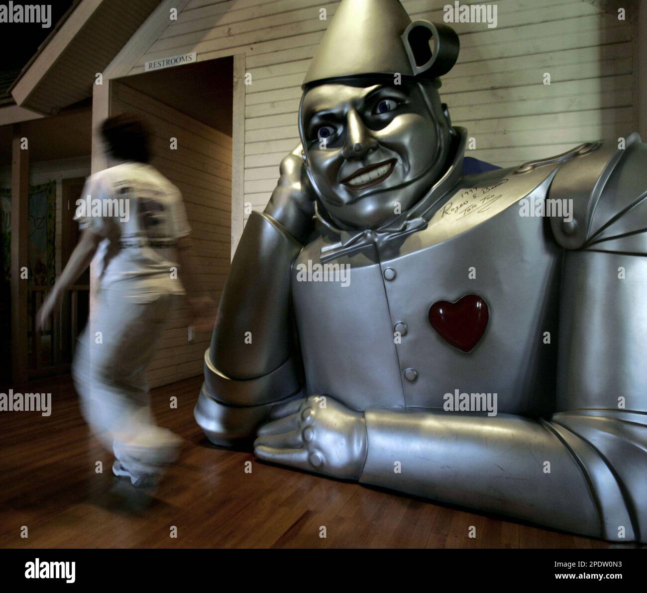 A larger-than-life likenesss of the tin man dwarfs a passerby at the ...