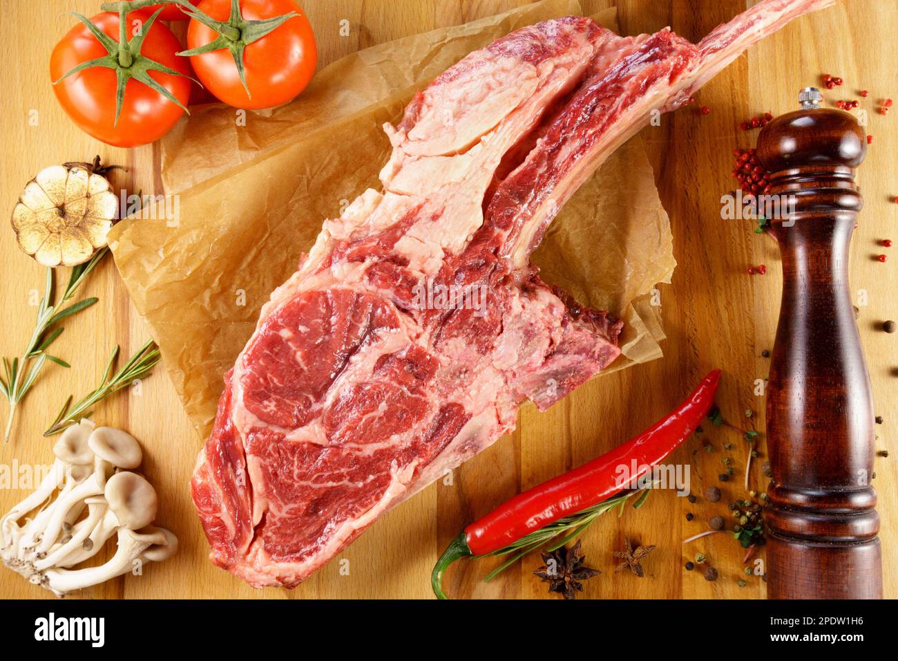 Raw cowboy steak on wooden background, prime rib eye on bone Stock ...