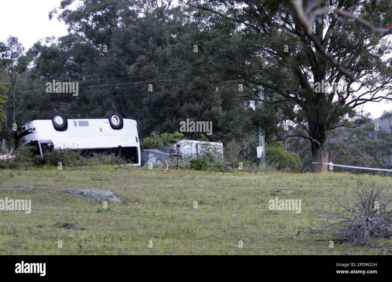 A tourist bus lies on its roof after a fatal accident in Jamberoo, 100 ...
