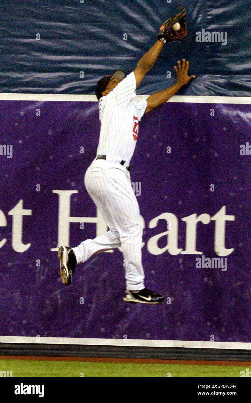 Minnesota Twins Jacque Jones goes up against the right field wall to ...