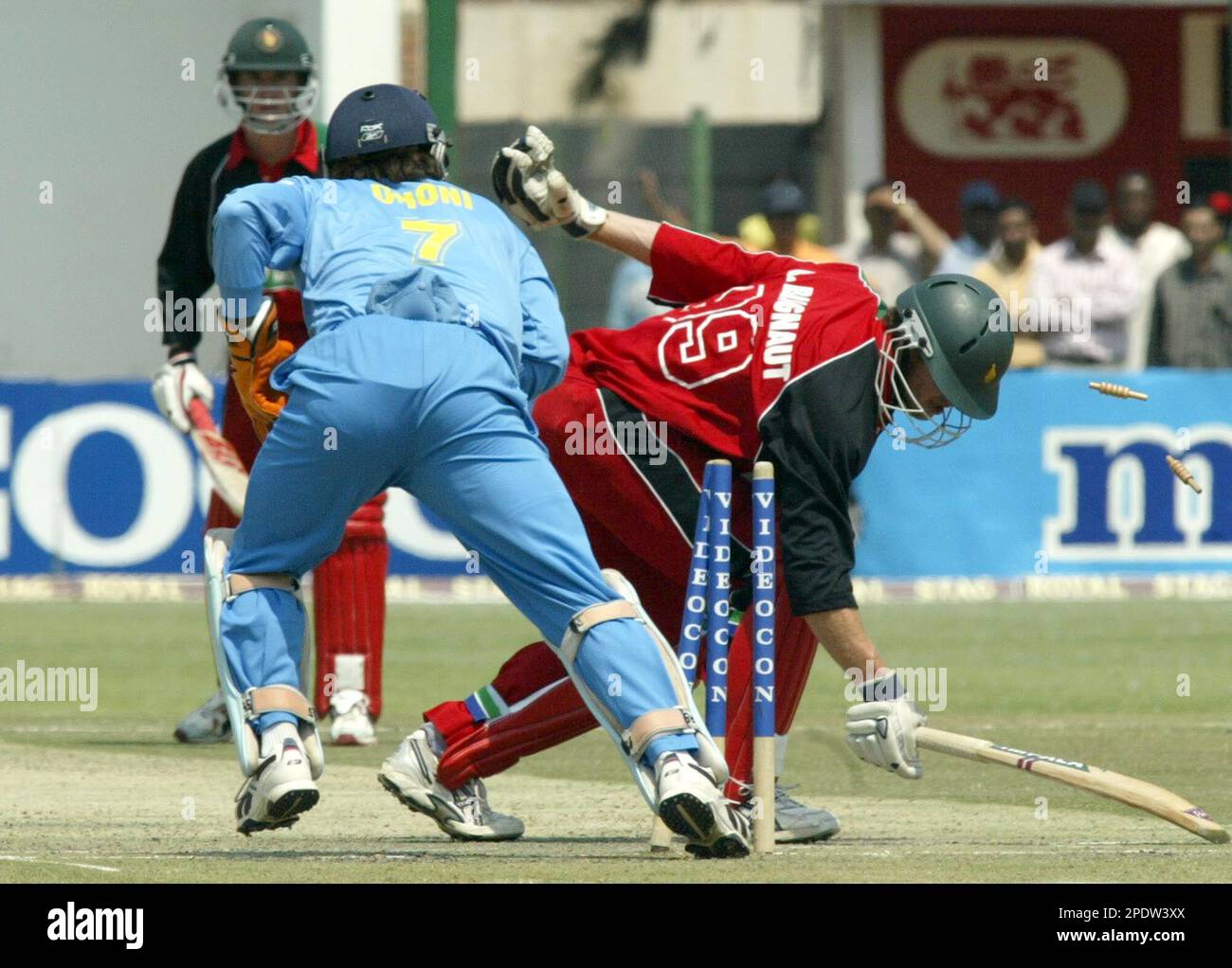 Indian wicket keeper MS Dhoni, left, stumps Zimbabwean batsman Andy ...