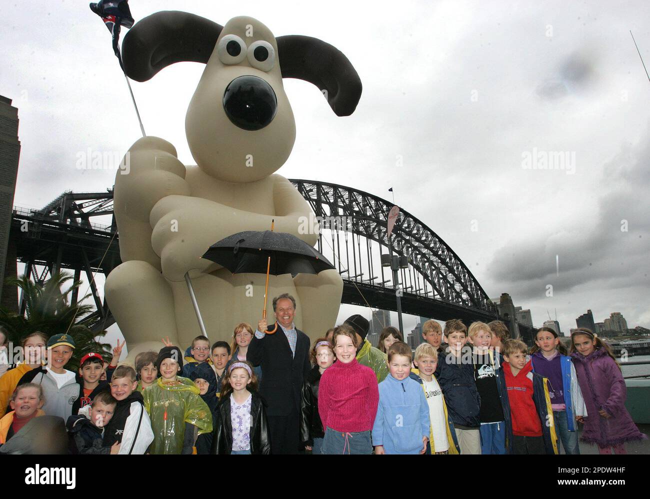Director Nick Park center, and a large group of children stand under a ...
