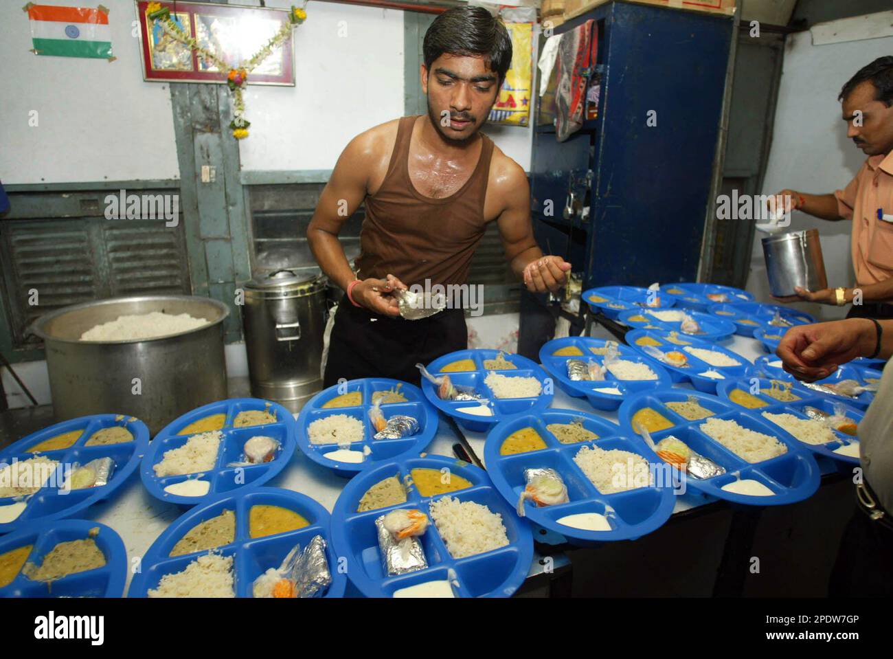 Indian railway workers prepare dinner for the passengers in a pantry ...