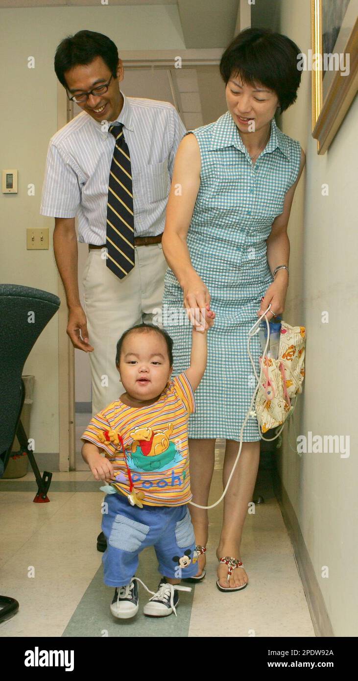 Yosuke Ohashi, 19-month-old, center, arrives with his father Yukiho ...