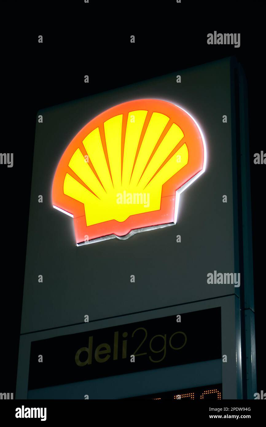 Shell logo glowing at night close-up Stock Photo - Alamy