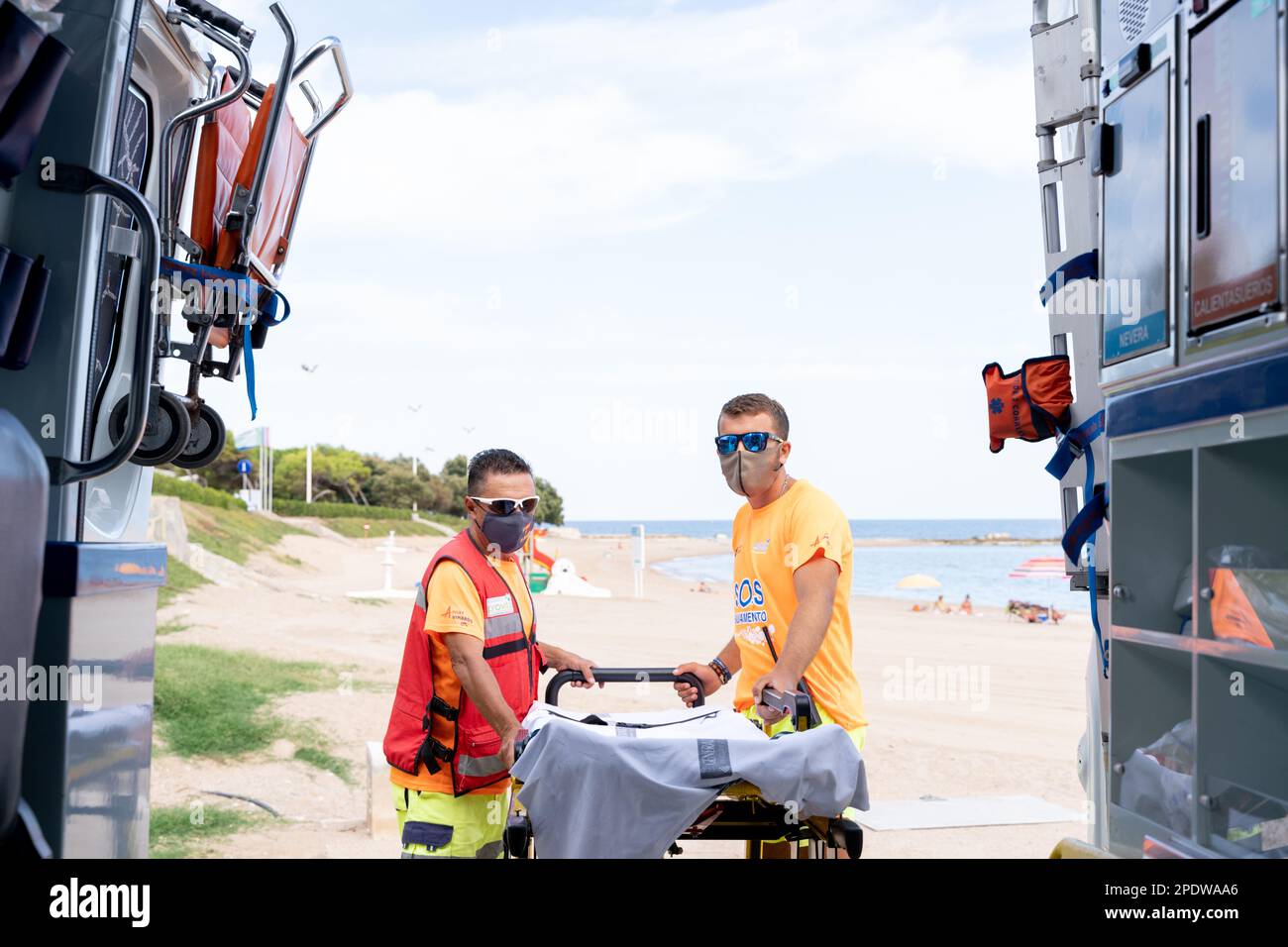 First aid team working on the beach using the stretcher from an ...