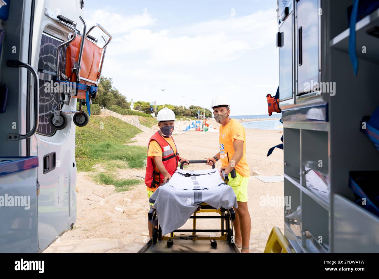 Lifeguard staff working on the beach using a stretcher from an ...