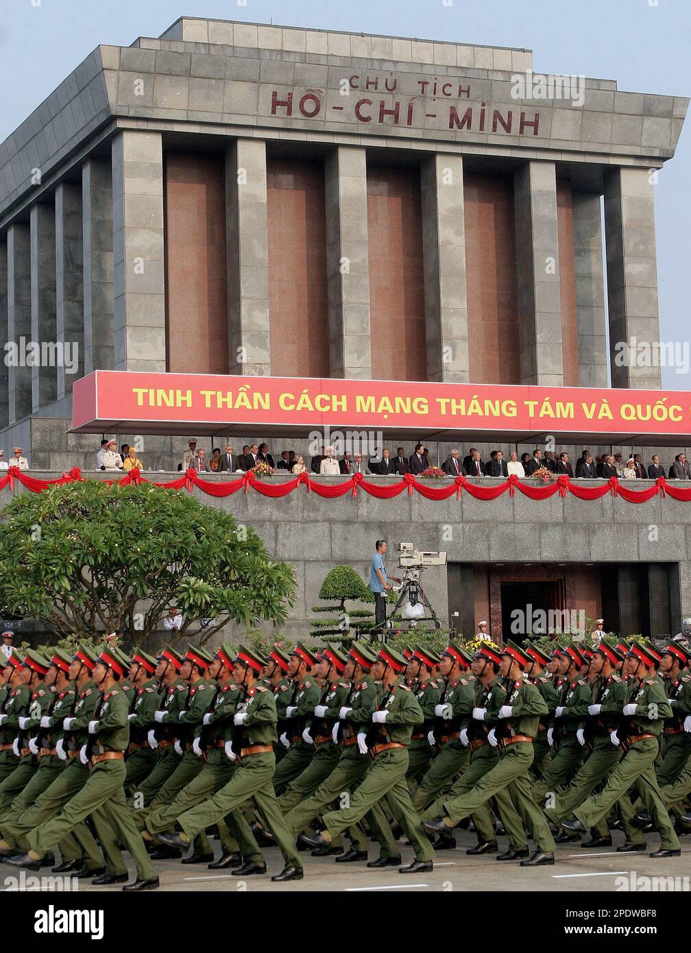 Vietnamese soldiers march past the mausoleum of former communist leader ...