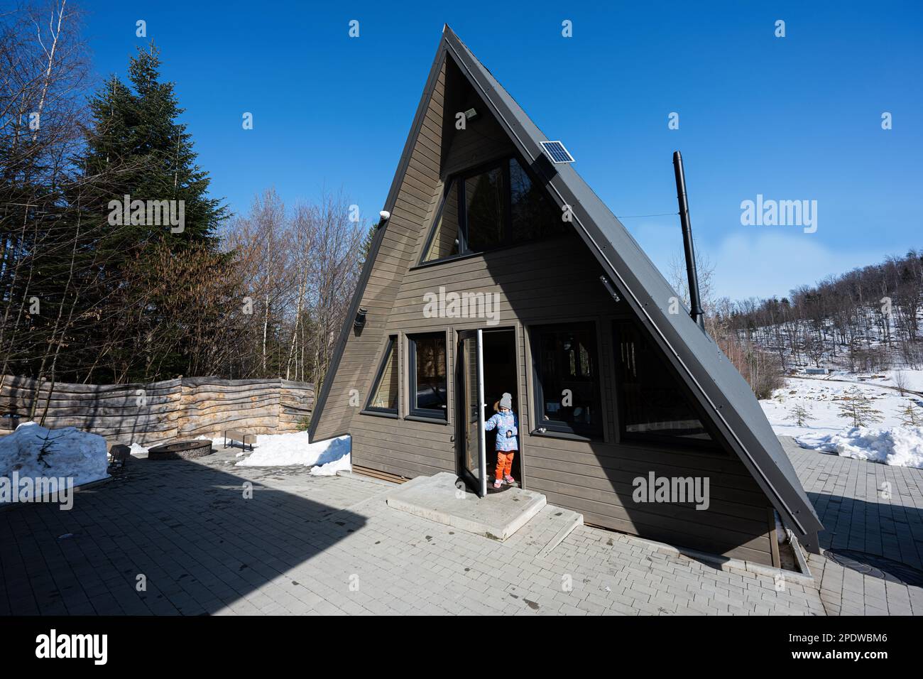 Little girl stand in door of triangle country tiny cabin house in ...