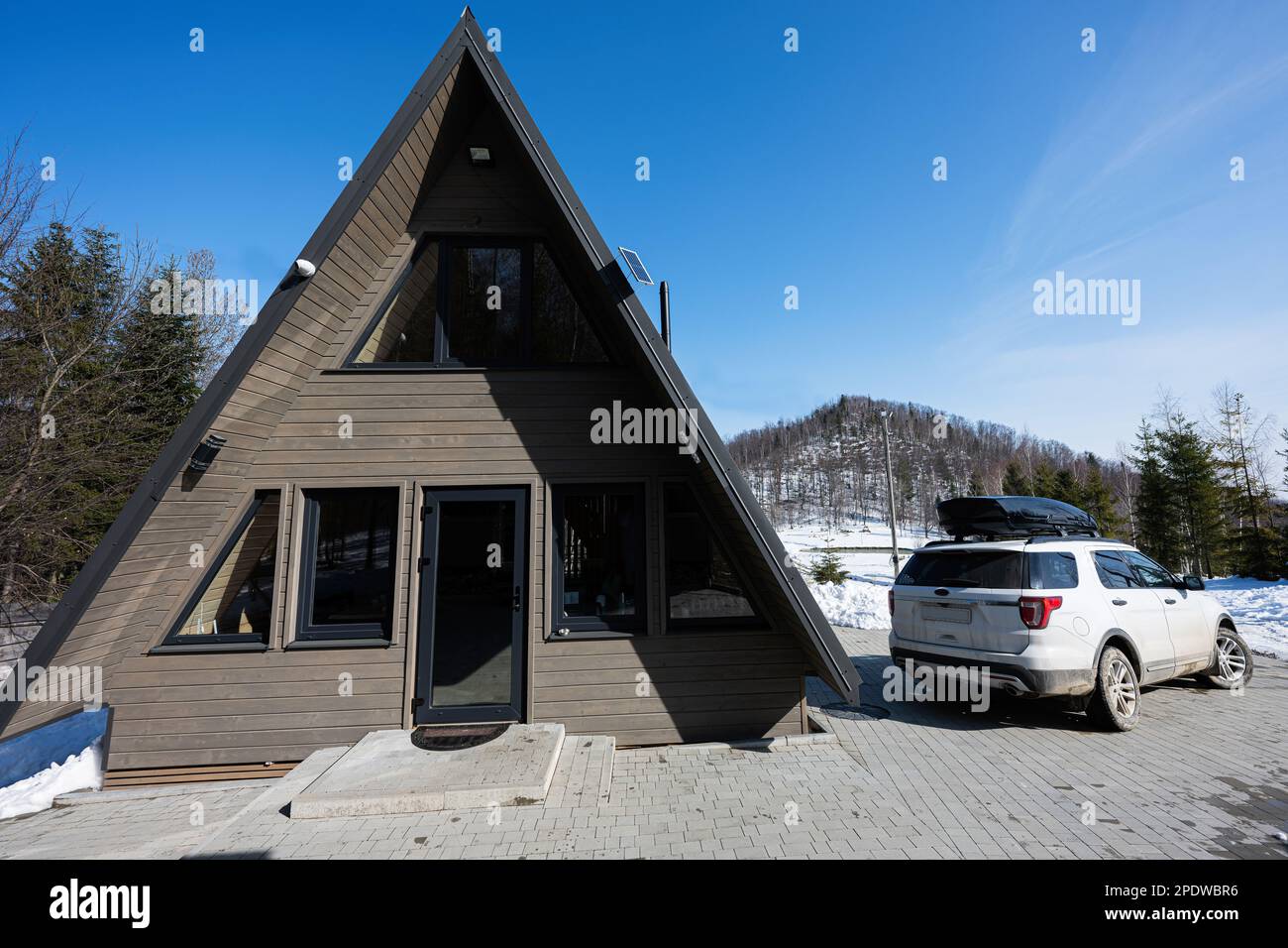 Wooden triangle country tiny cabin house and suv car with roof rack in ...