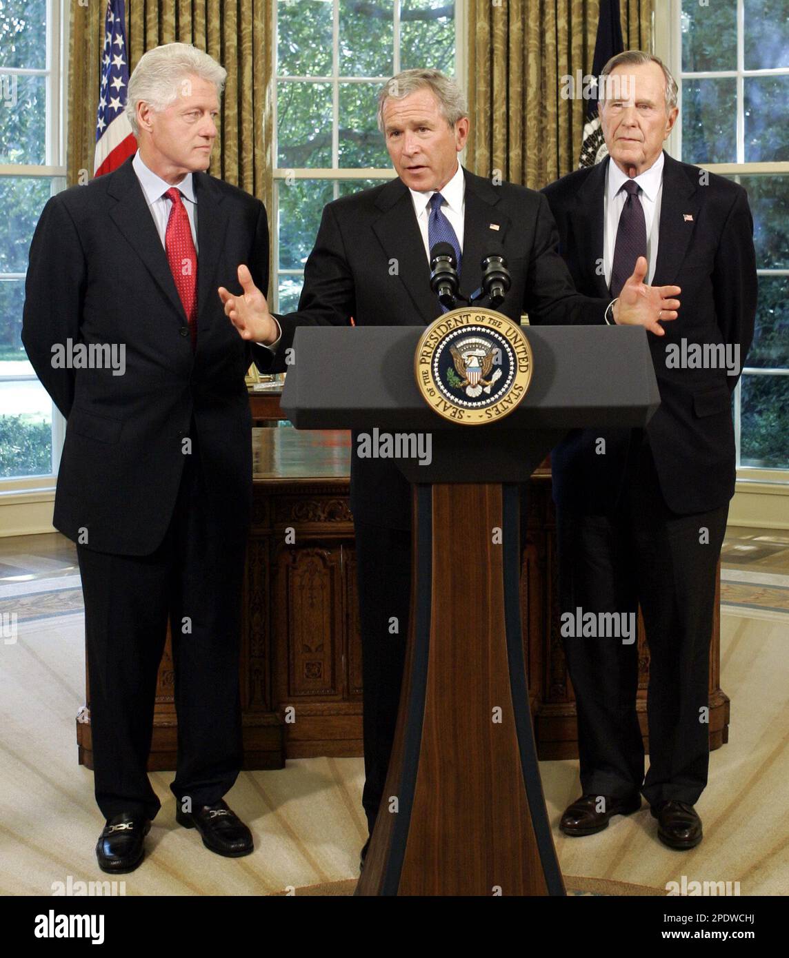 President Bush meets with former President George H.W. Bush, right, and ...