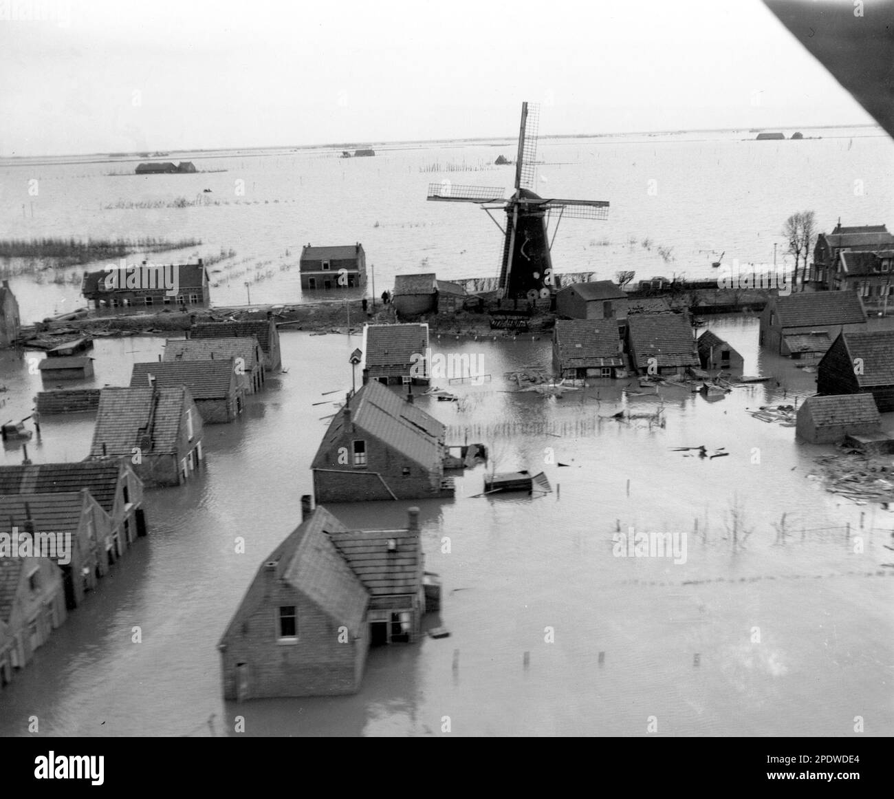 This aerial view shows a windmill pump high and dry amidst the flood ...