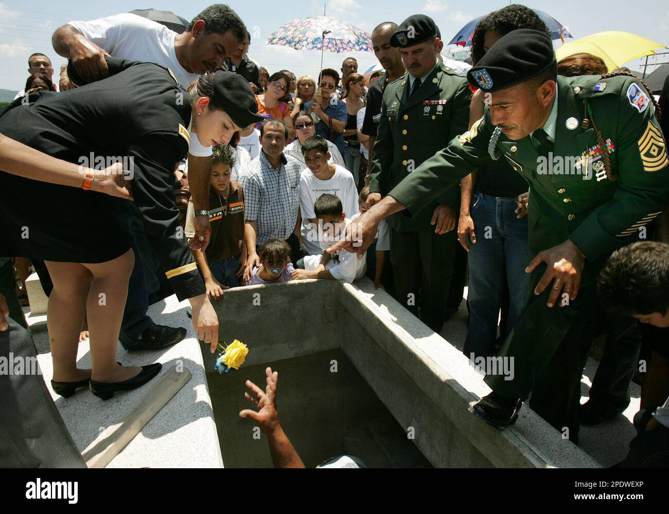 Above a cemetery crypt, U.S. Army soldier 1st Lt Nancy Negron, left, is ...