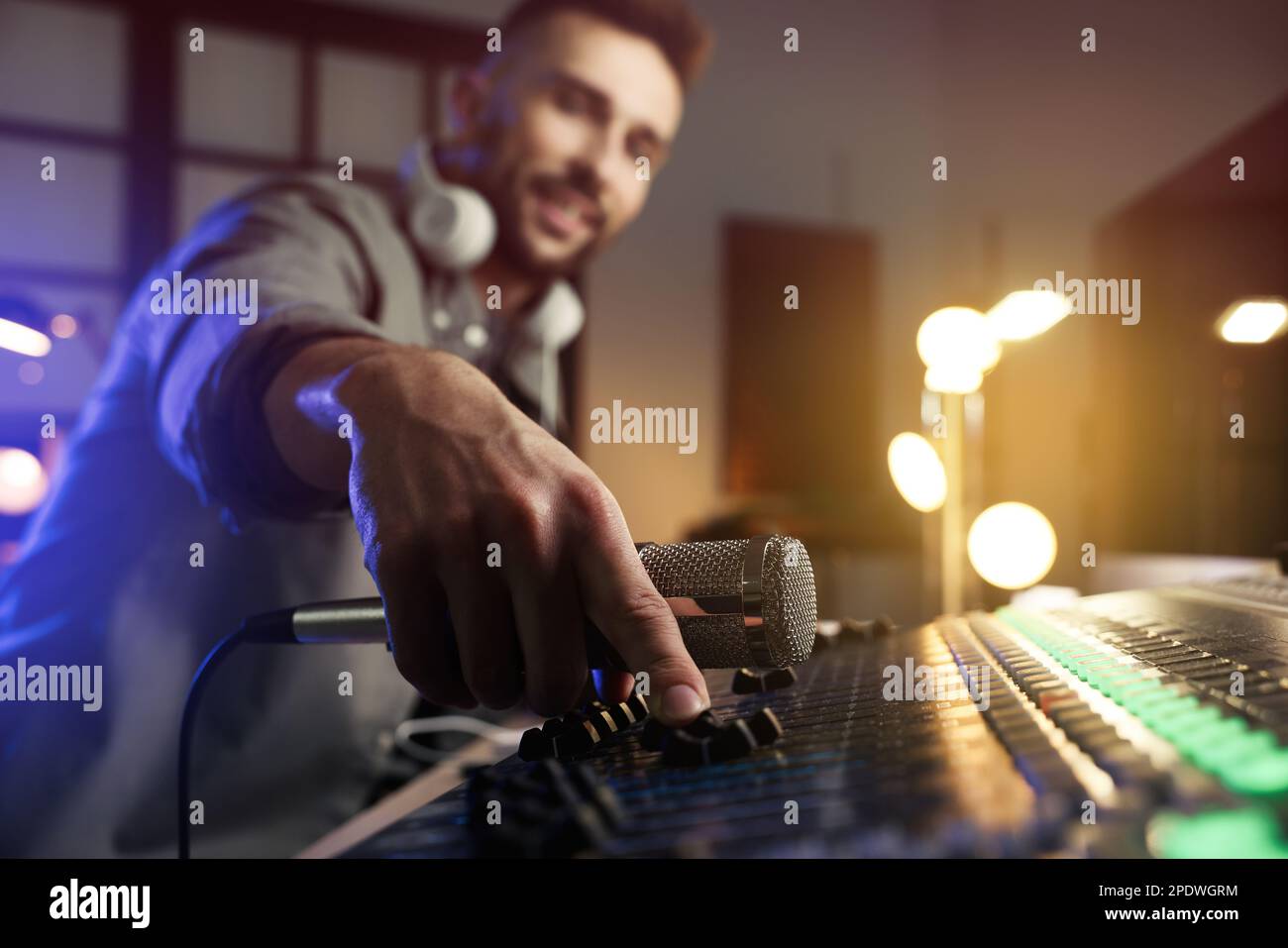 Man working in modern radio studio, focus on professional mixing ...