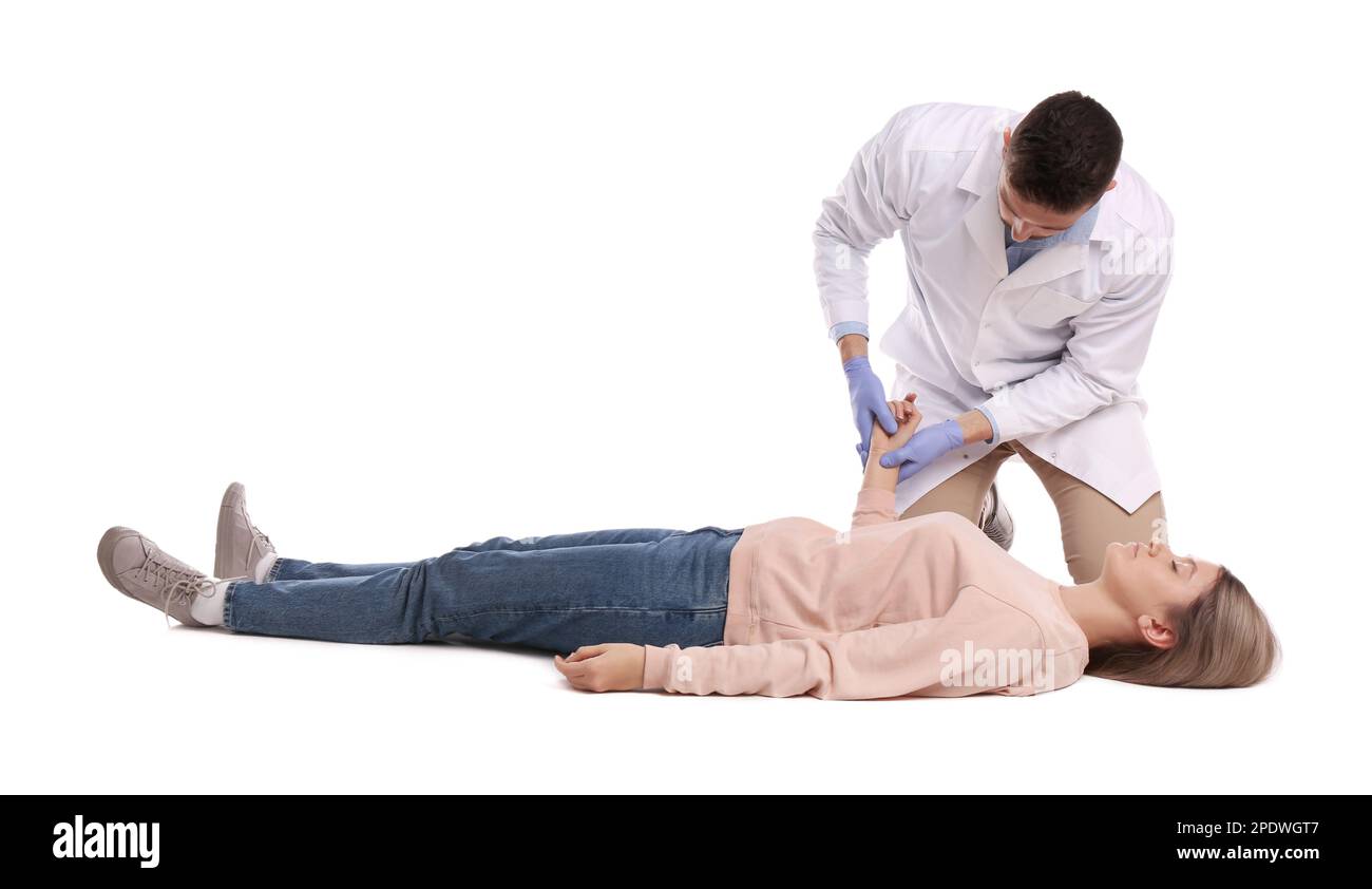 Doctor in uniform performing first aid on unconscious woman against ...