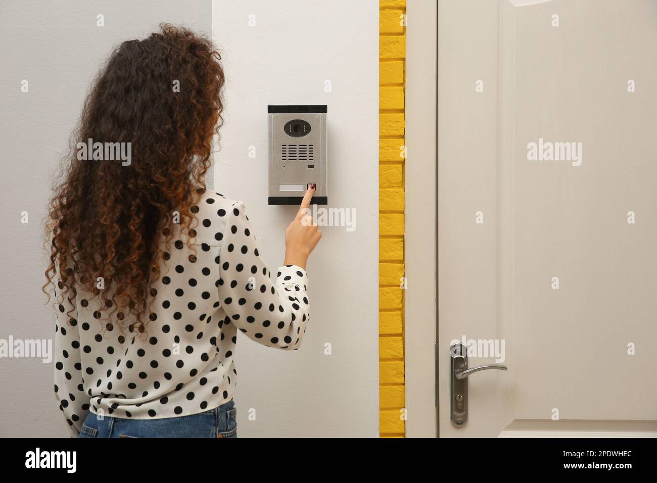 Adult woman ringing door bell hi-res stock photography and images - Alamy