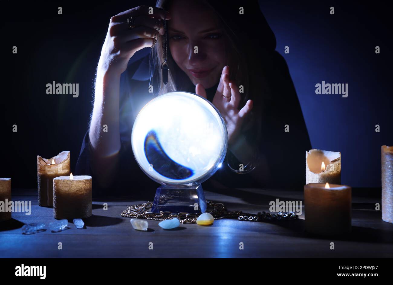 Soothsayer Using Crystal Ball To Predict Future At Table In Darkness