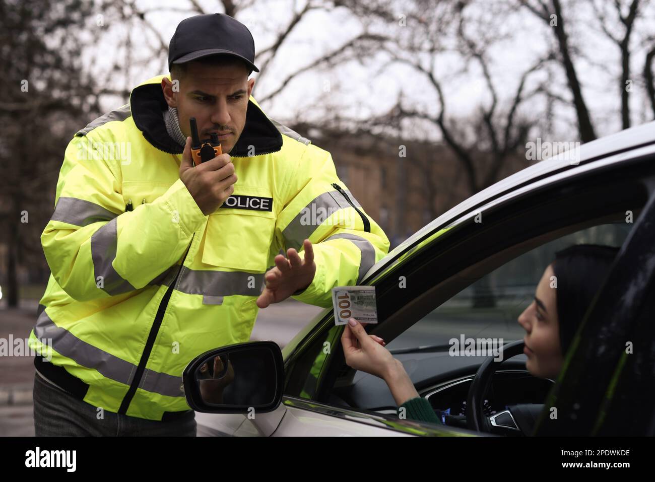 Police officer rejecting bribe near car outdoors Stock Photo - Alamy