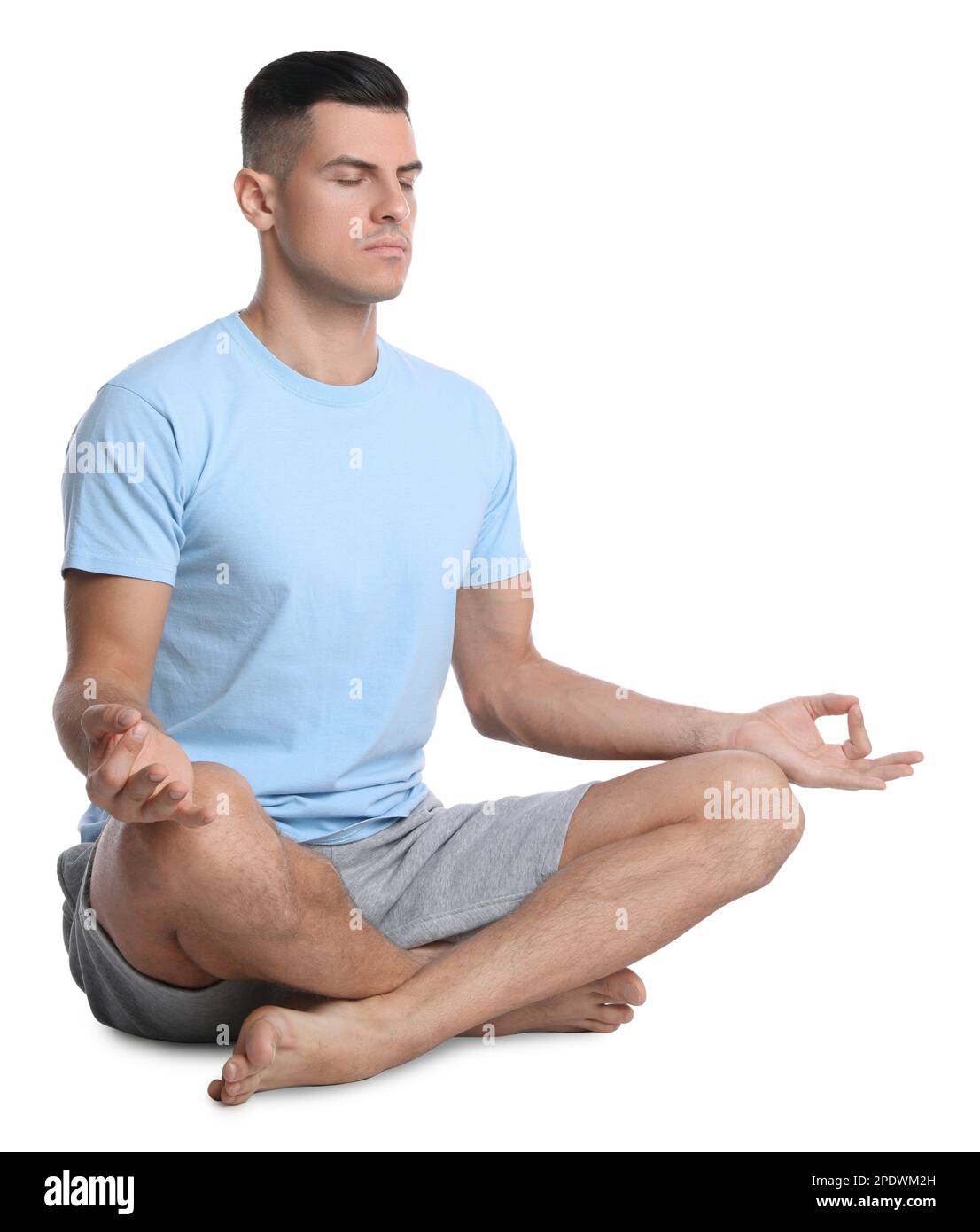 Handsome man meditating on white background. Harmony and zen Stock ...