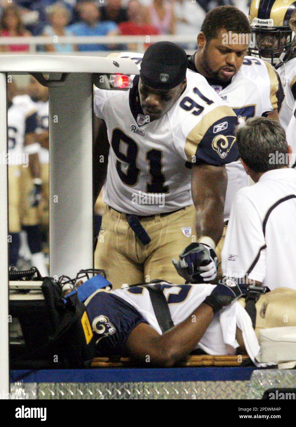 St. Louis Rams defensive end Leonard Little (91) grasps teammate Terry ...