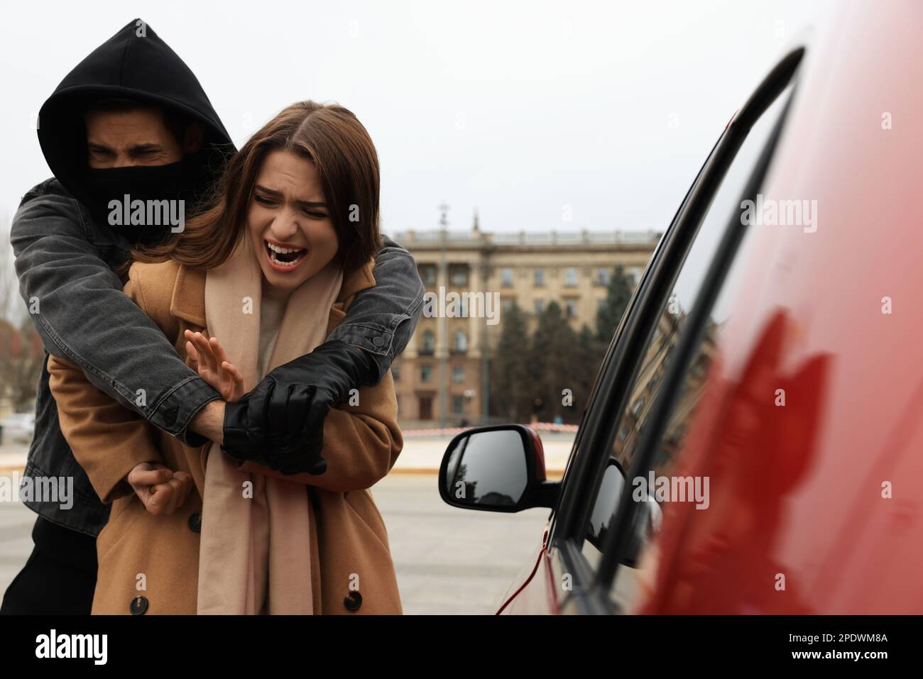 Woman defending herself from attacker near car outdoors Stock Photo - Alamy