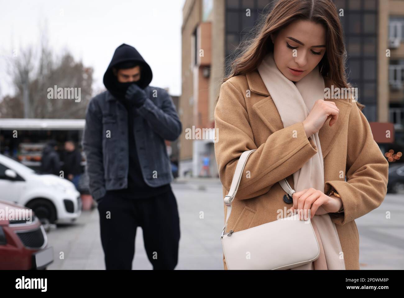 Man stalking young woman on city street Stock Photo - Alamy